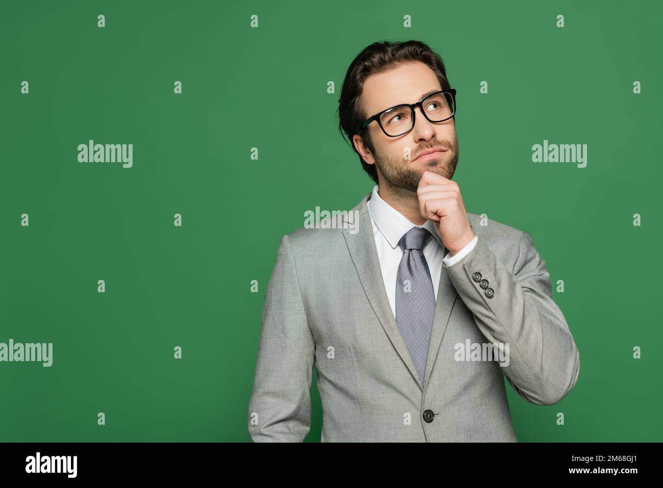 Pensive newscaster in eyeglasses and suit looking away isolated on ...