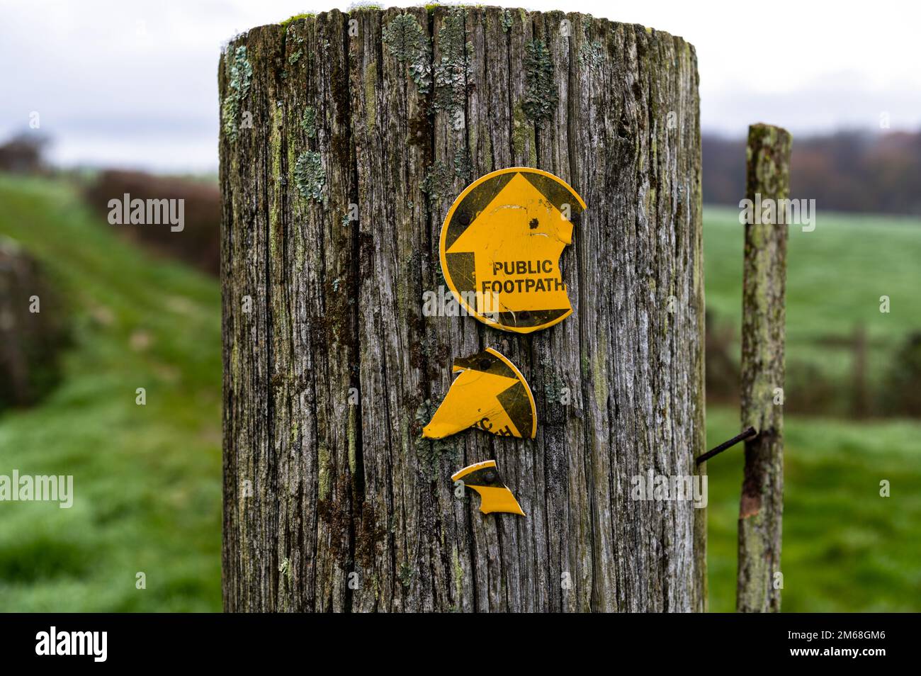 Footpath direction sign on an old wooden post, England Stock Photo - Alamy