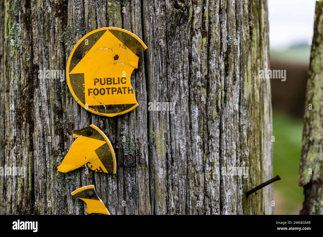 Footpath direction sign on an old wooden post, England Stock Photo - Alamy