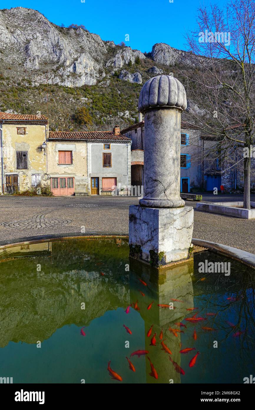Fountain with goldfish in The small village and castle at Roqefixade ...