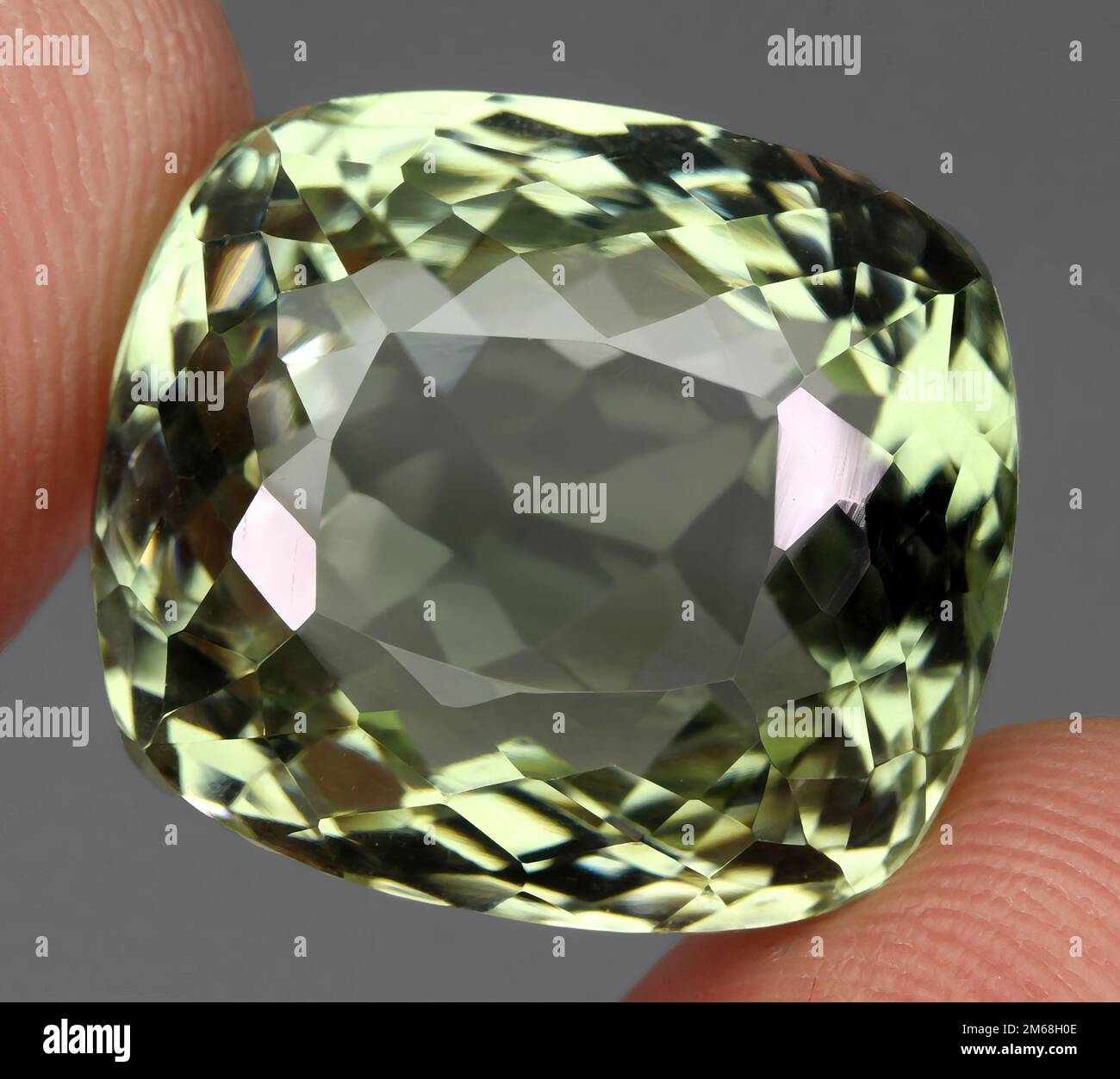 Natural gemstone green amethyst on a gray background Stock Photo - Alamy