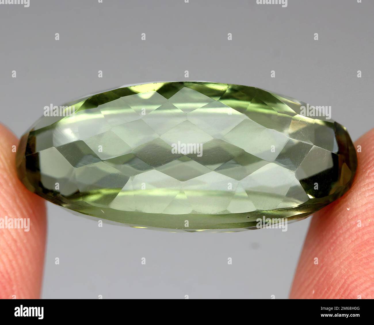 Natural gemstone green amethyst on a gray background Stock Photo - Alamy