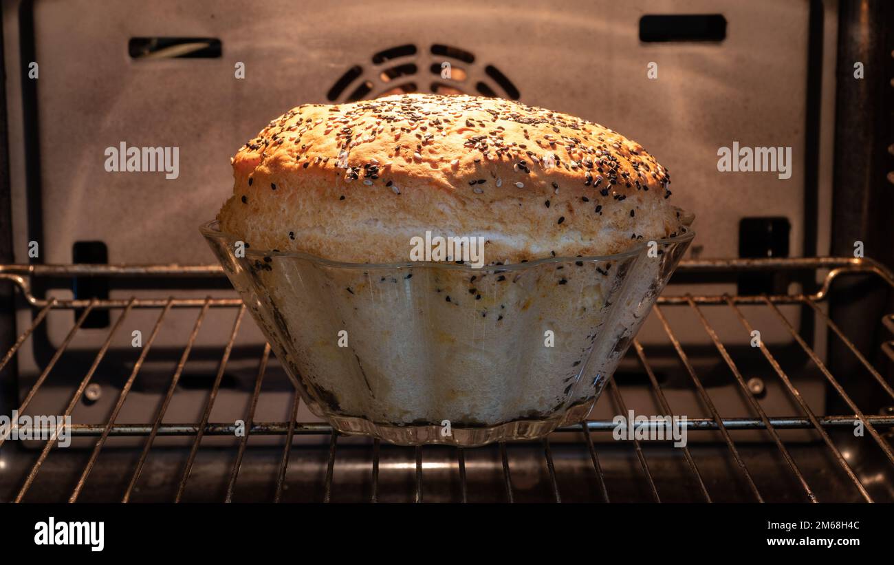 Delicious, warm homemade bread in oven with black cumin seeds, freshly ...
