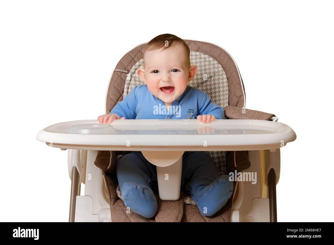 Happy baby sits on a high chair for feeding children, isolated on a ...