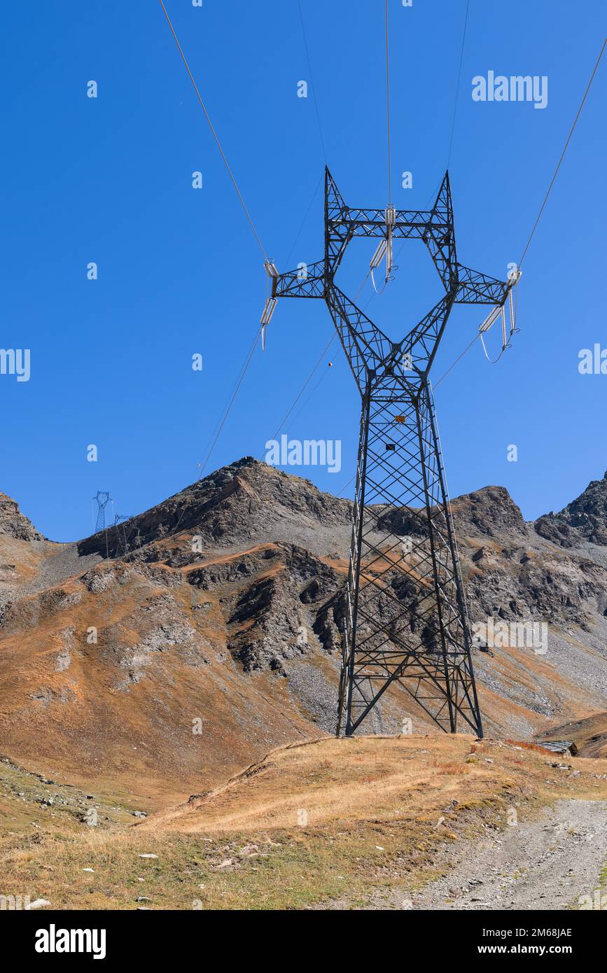 Metal mast and wires of high-voltage power line installed on slope ...