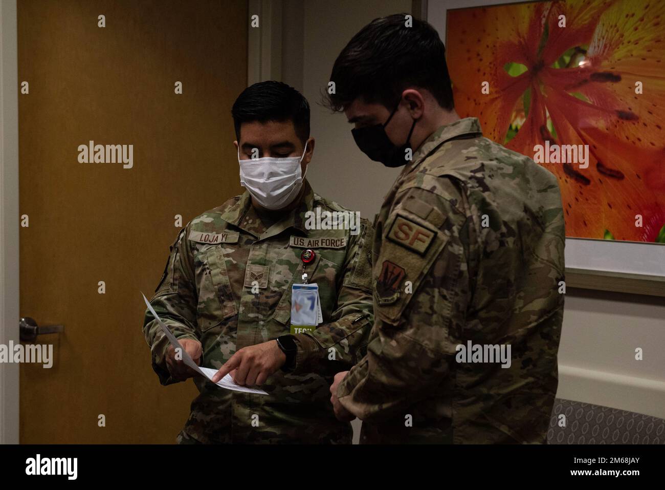 A member of the 633d Medical Group reviews medical readiness with a ...