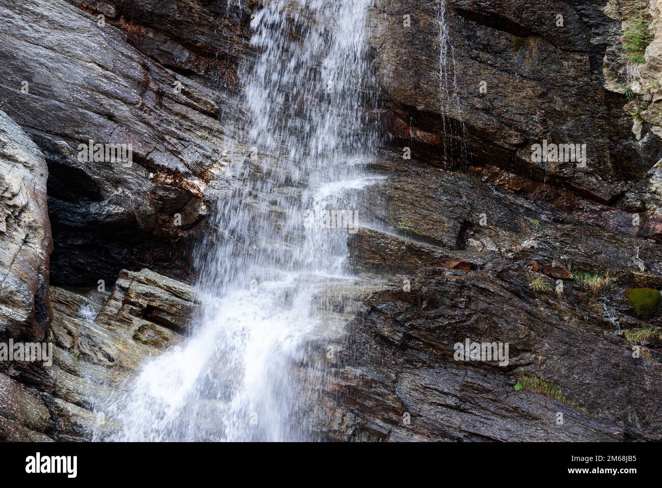 Mountainous alpine karst rocks washed with water with moss residues in ...