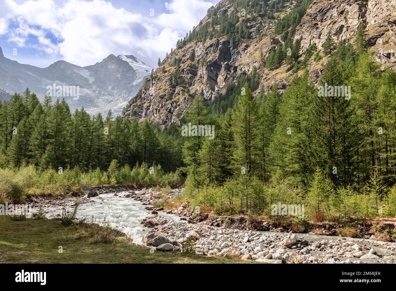 Foaming rushing water stream along rocky rapids in gorge between ...