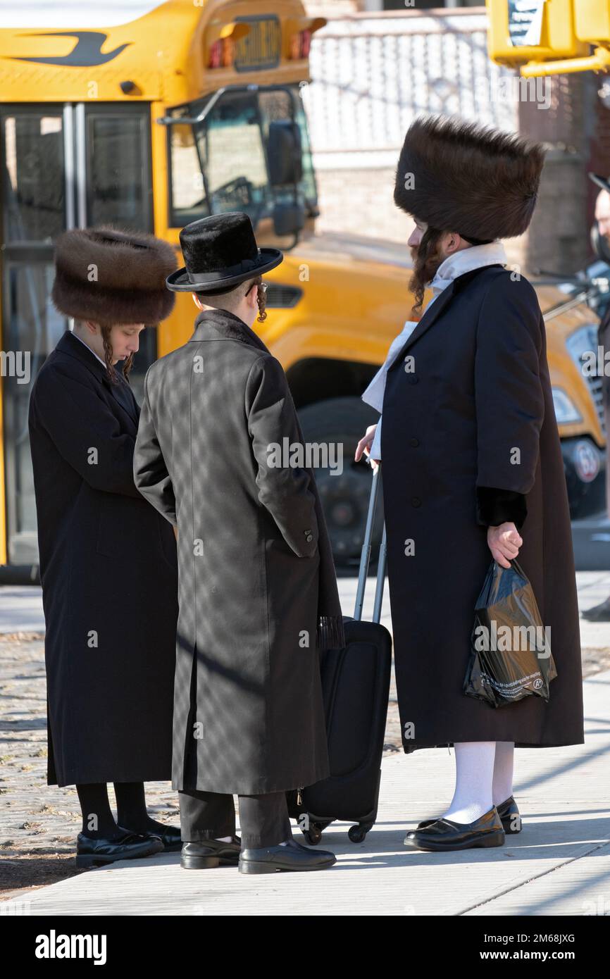 On a Friday afternoon, a Hasidic family waits for a bus to take them ...