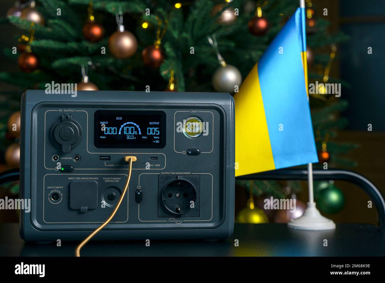 Portable charging station and the flag of Ukraine on the background of ...