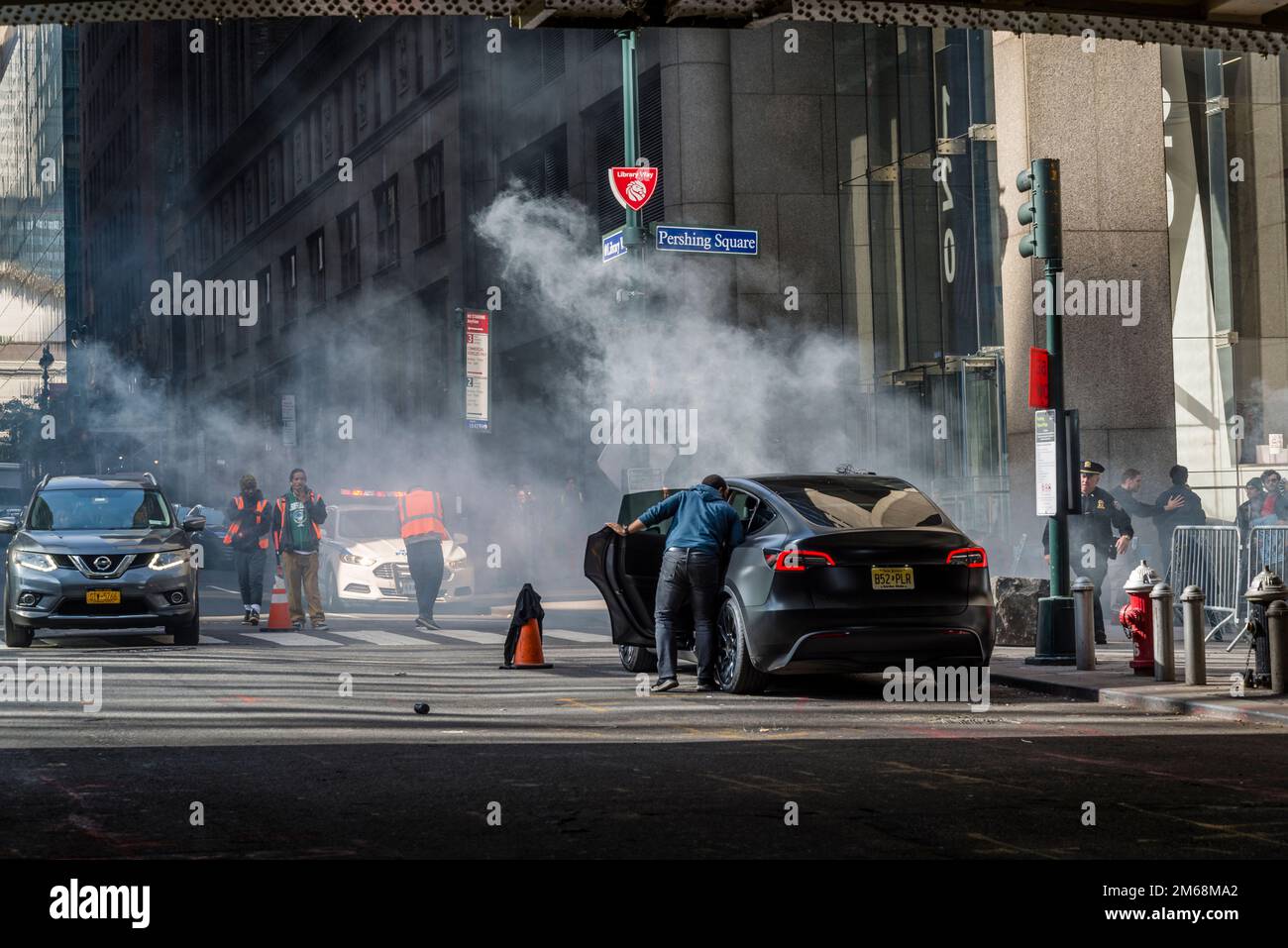 Car in smoke, shooting an advertisement, Midtown Manhattan, New York ...