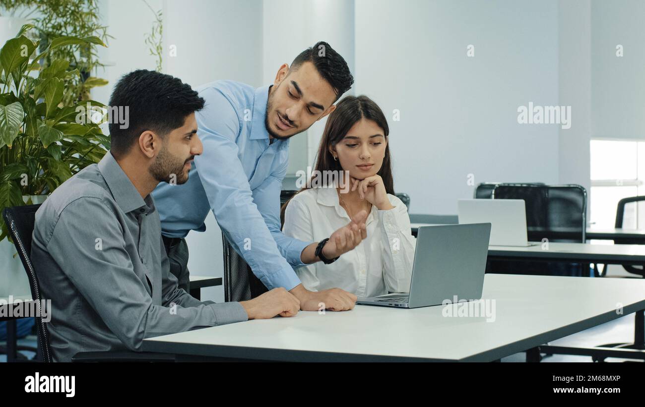 Indian man businessman manager mentor helping coworkers colleagues new ...