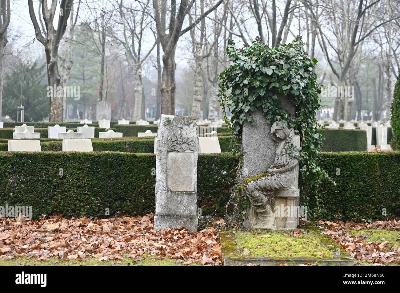 Vienna, Austria. Vienna Central Cemetery.Seated stone statue in front ...