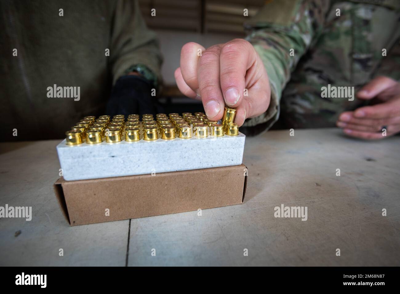 New Jersey Army National Guard Soldiers load M17 pistol clips during ...