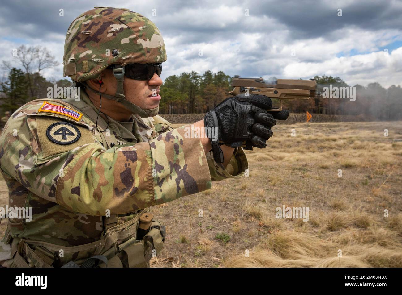 U.S. Army Sgt. Kevin Abreu, Bravo Battery, 3-112th Field Artillery Regiment, fires an M17 pistol ...