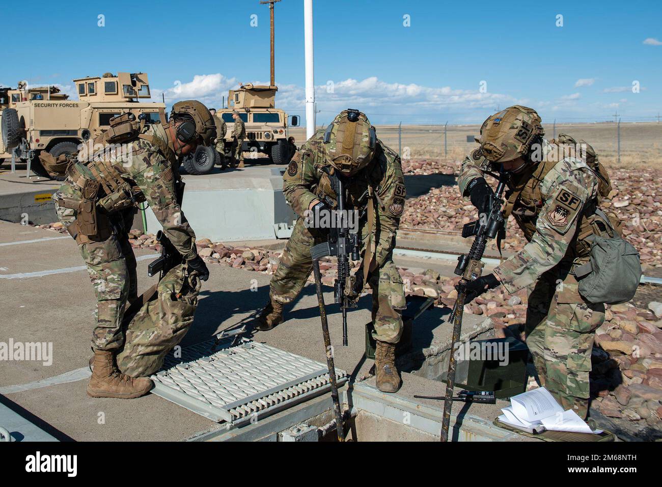 Three members from the 341st Missile Security Operations Squadron tactical response force secure ...