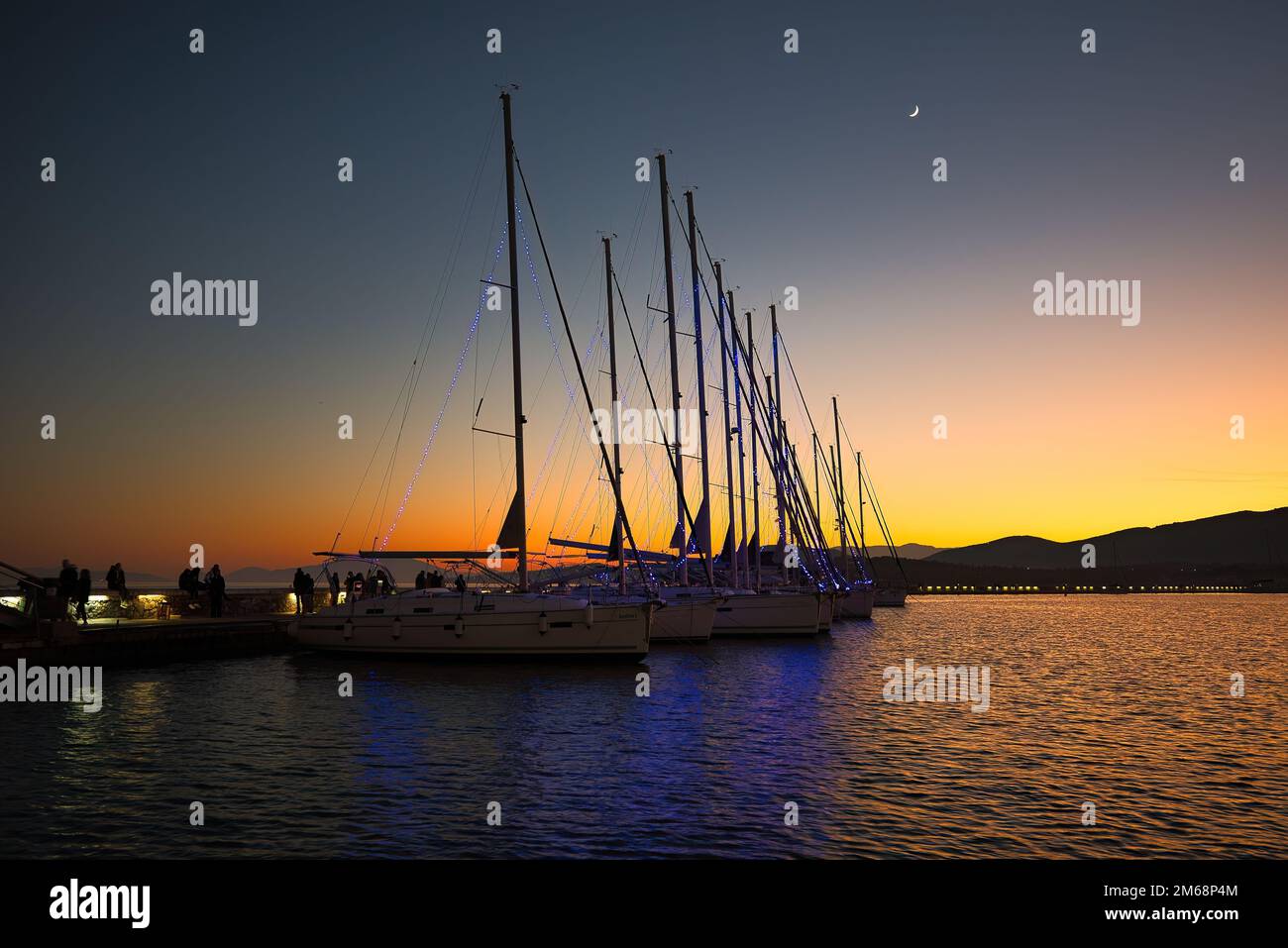 beautiful sailboats in the harbor decorated at sunset, Volos, Greece ...