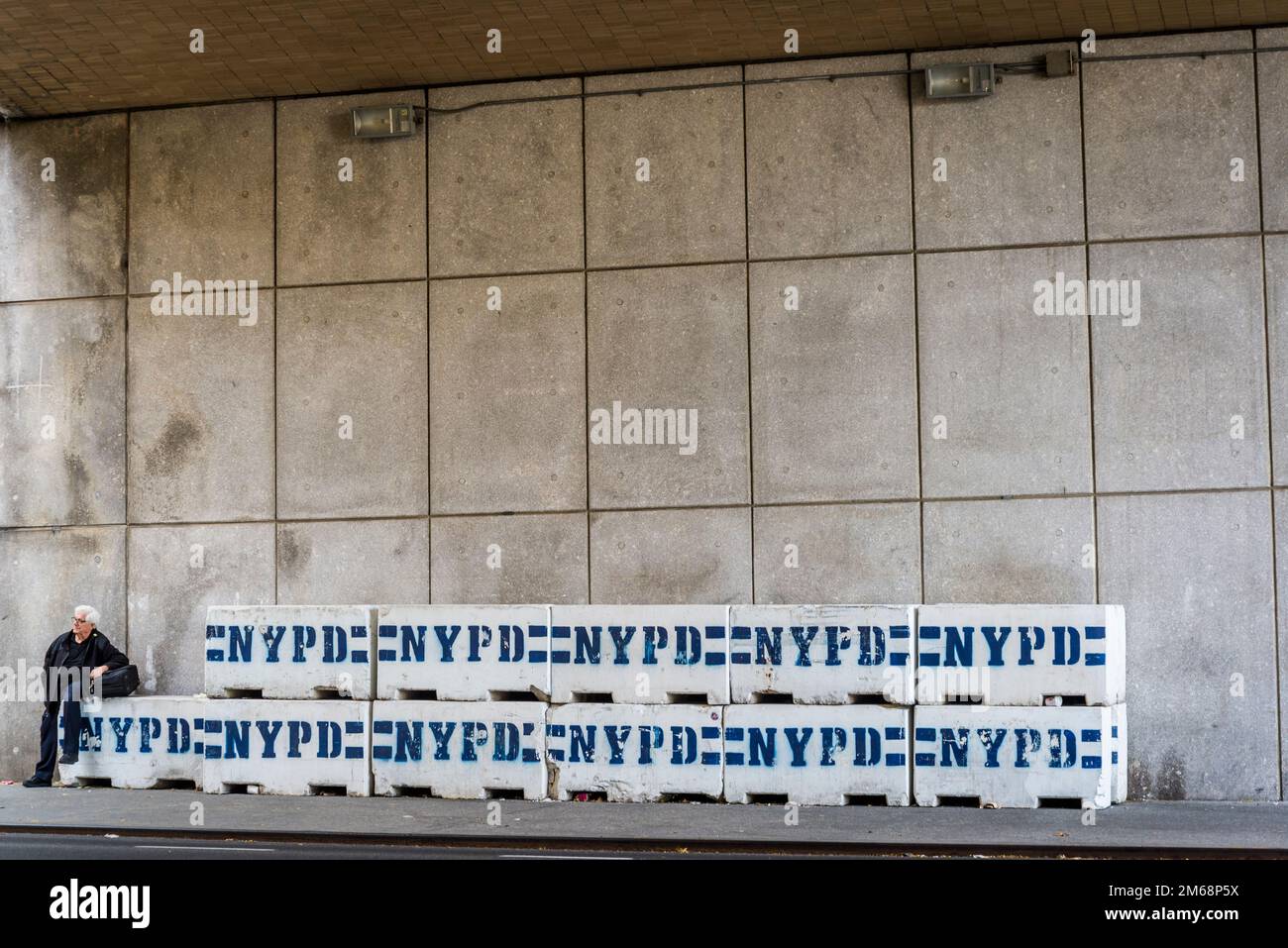 Man sitting on NYPD concrete barrier blocks ready to be deployed in ...