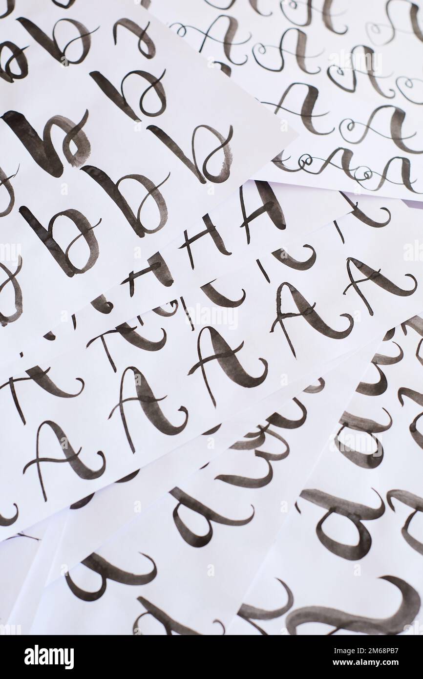 Several white sheets with calligraphic exercises. Calligraphy practice ...