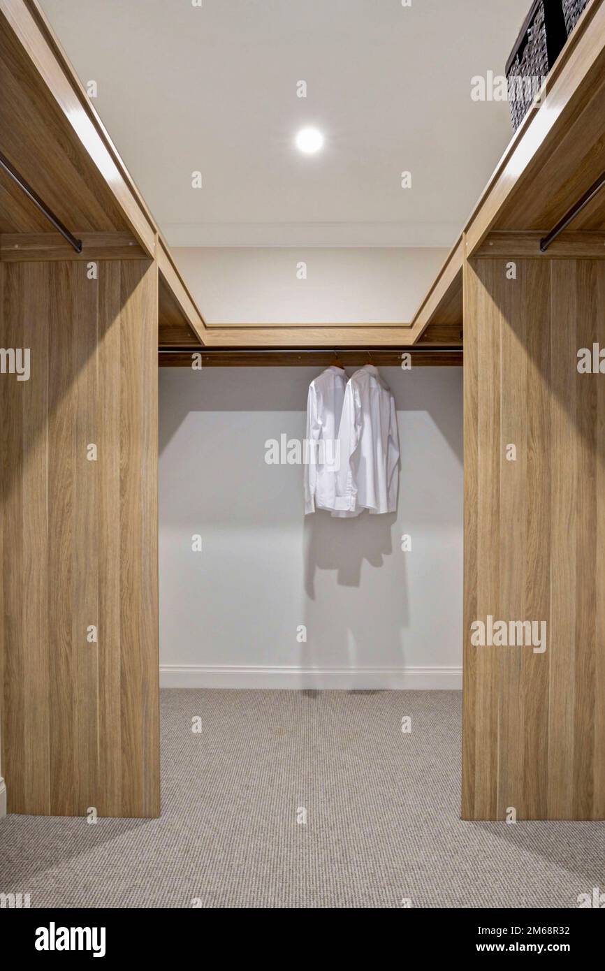 Walk in robe with two white business shirts hanging Stock Photo - Alamy