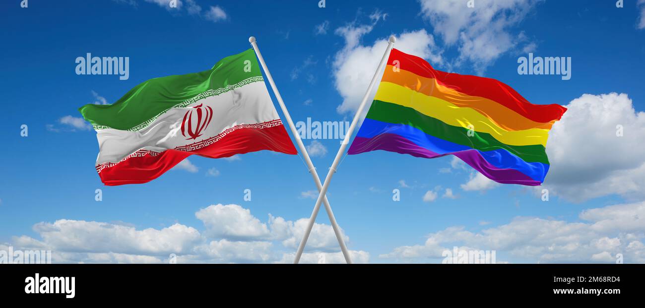 two crossed flags LGBT Pride and Iran waving in wind at cloudy sky ...