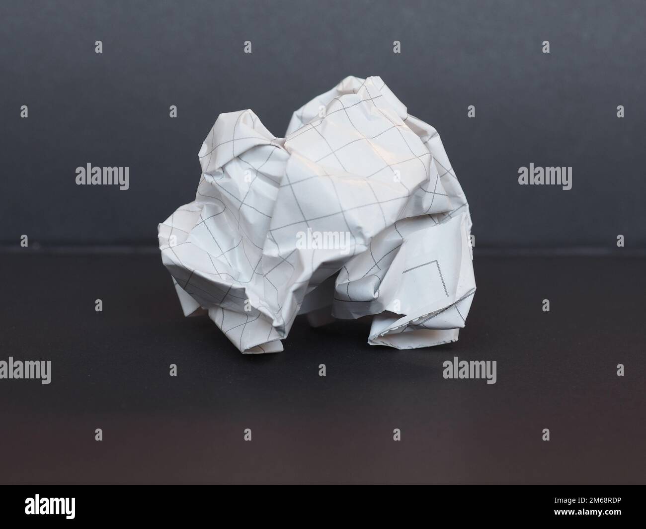 white paper ball over a dark grey background Stock Photo - Alamy
