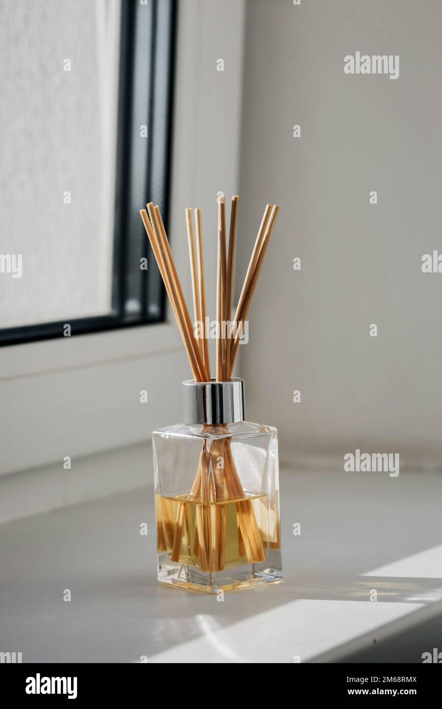 Glass jar with wooden aroma sticks. Aroma reed diffuser Stock Photo - Alamy