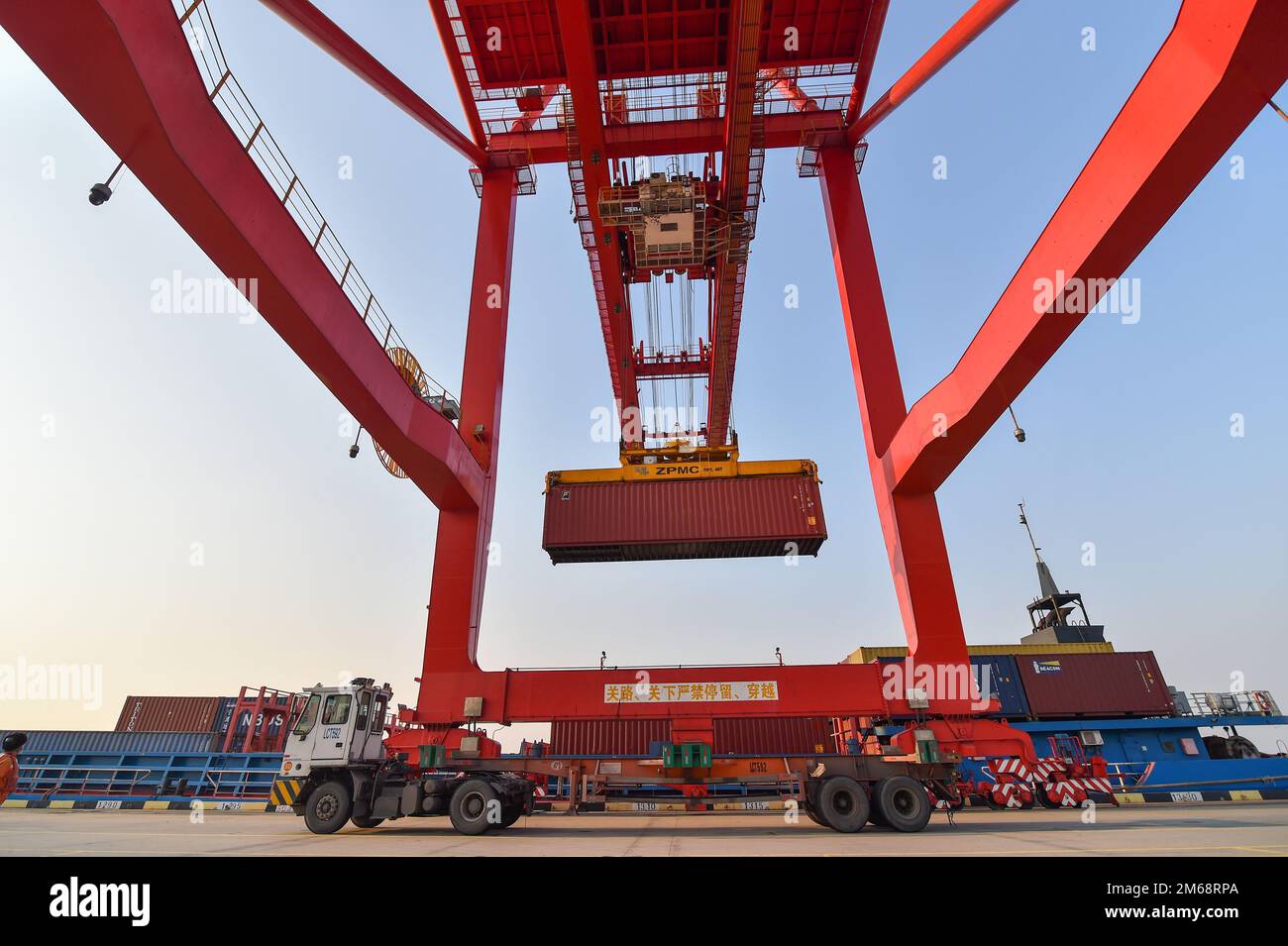 NANJING, CHINA - JANUARY 3, 2023 - Trucks load containers at the ...