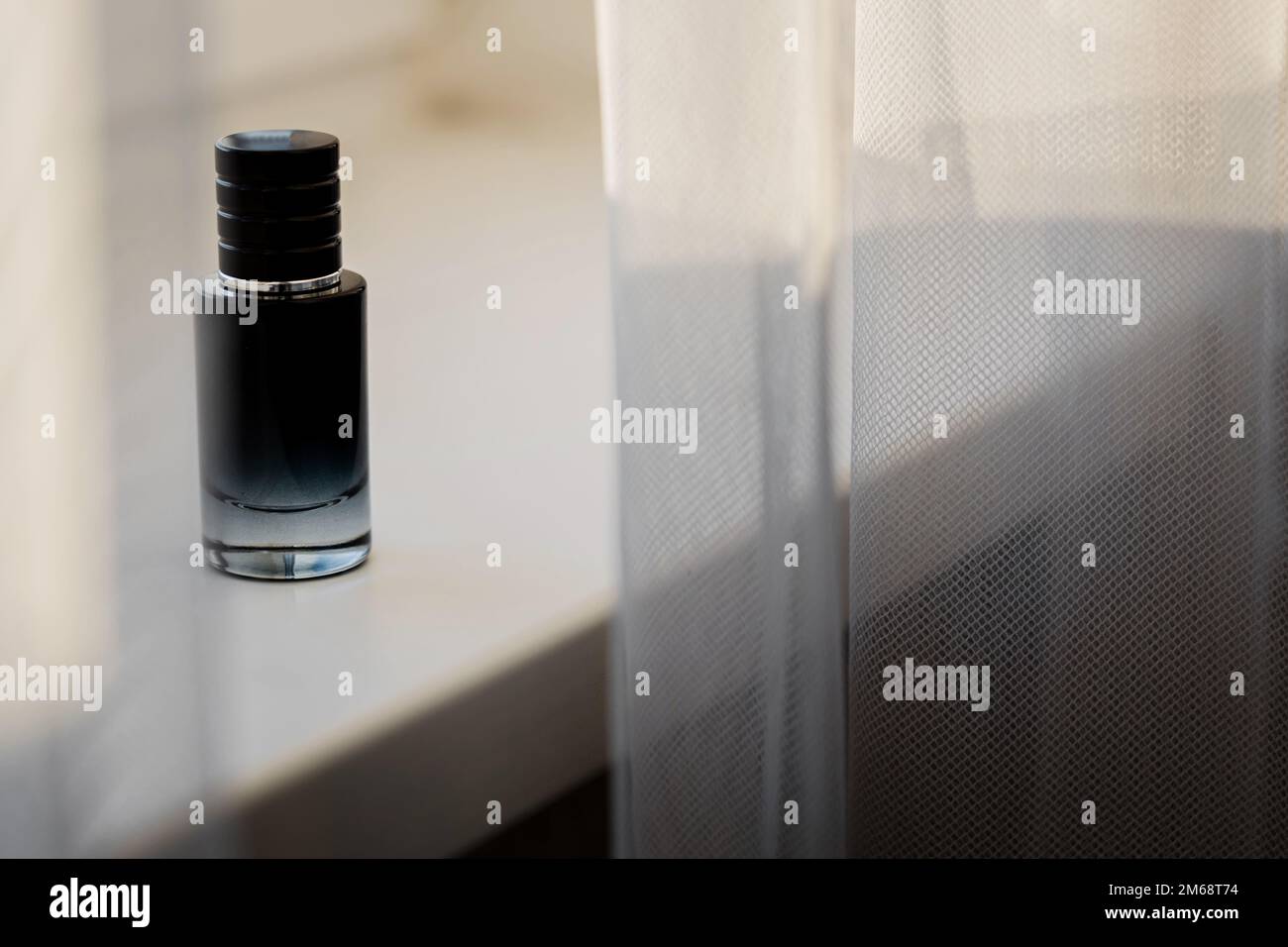 bottle of men's perfume on the window. mens perfume spray bottle Stock ...