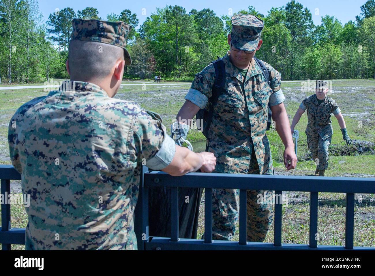 U.S. Marine Corps Pfc. Isaac Loma (middle), a financial management ...