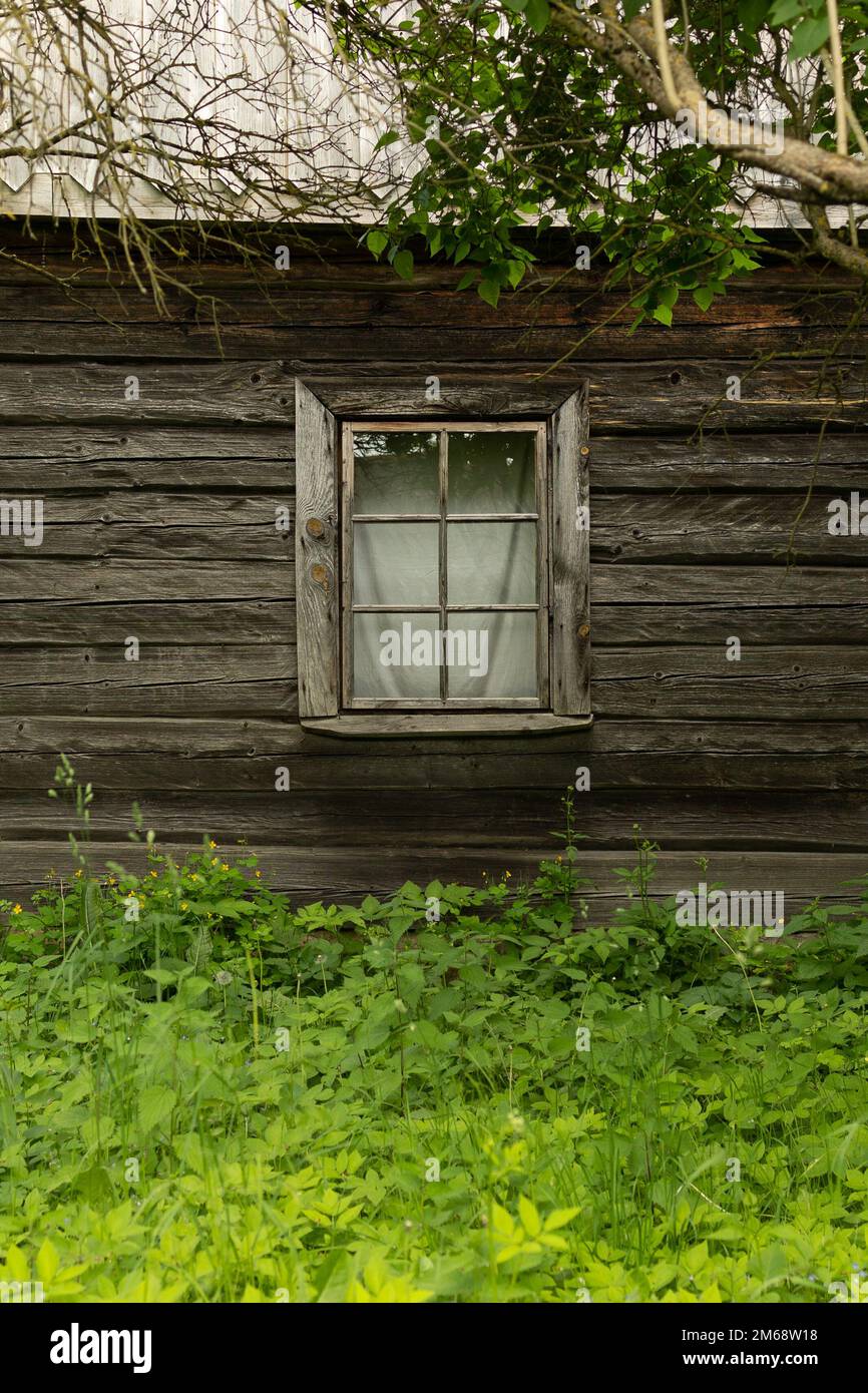 Texture background, window on the wall of a wooden and stone house ...
