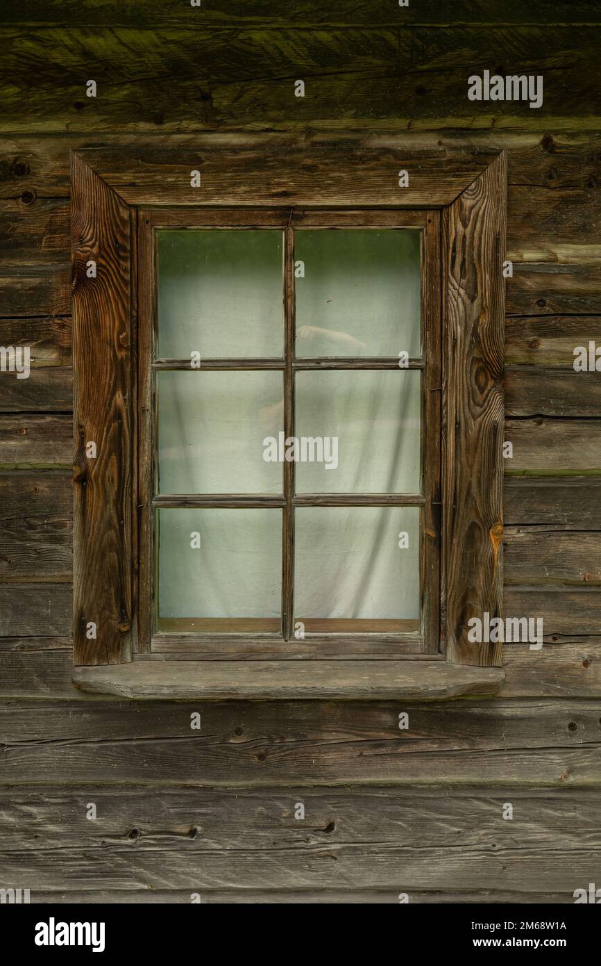 Texture background, window on the wall of a wooden and stone house ...