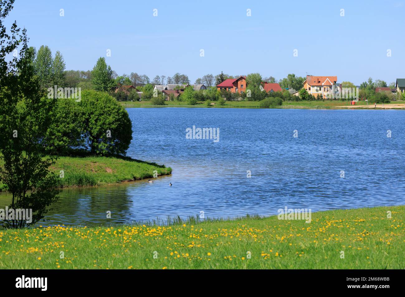 Buildings and houses standing on the shore of a lake, river or sea ...