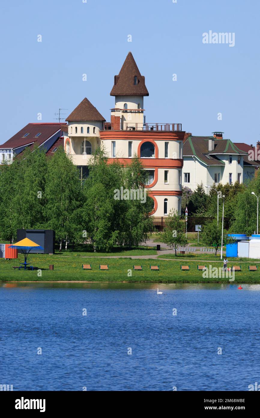 Buildings and houses standing on the shore of a lake, river or sea ...