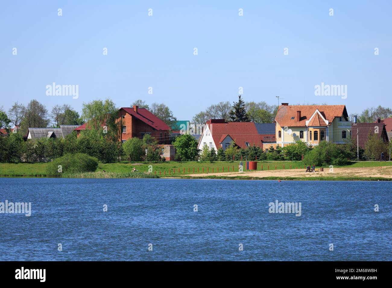 Buildings and houses standing on the shore of a lake, river or sea ...