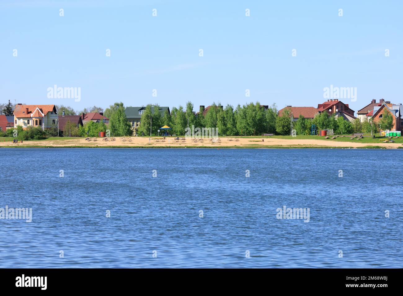 Buildings and houses standing on the shore of a lake, river or sea ...