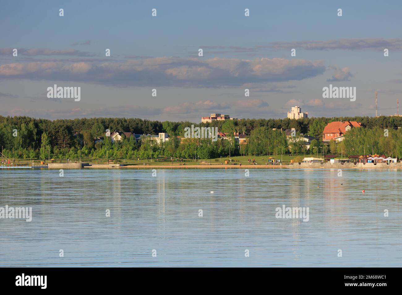 Buildings and houses standing on the shore of a lake, river or sea ...