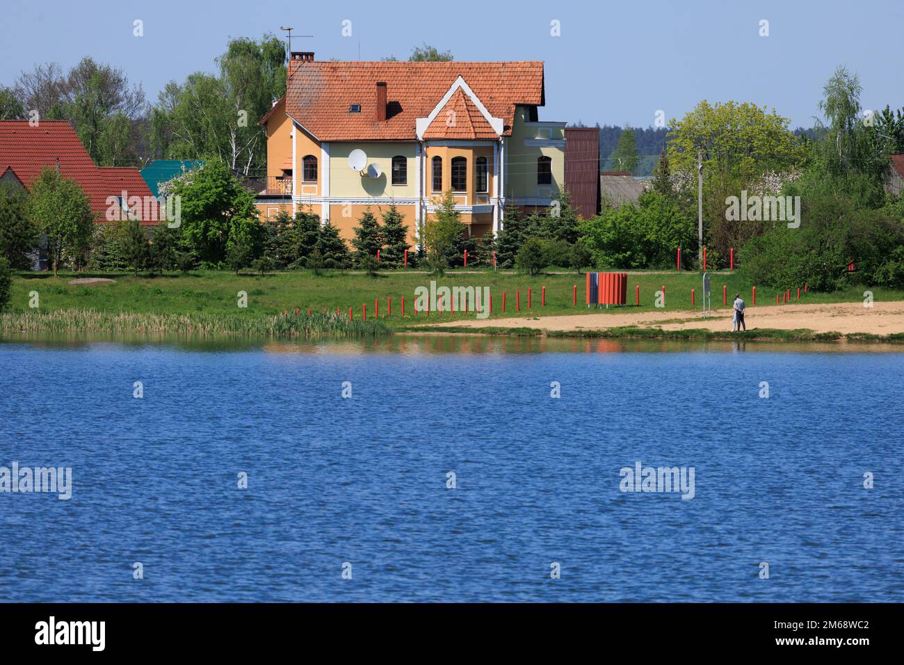 Buildings and houses standing on the shore of a lake, river or sea ...