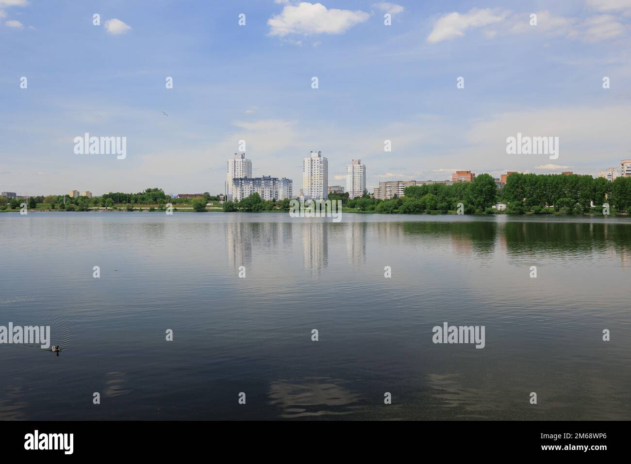 Buildings and houses standing on the shore of a lake, river or sea ...