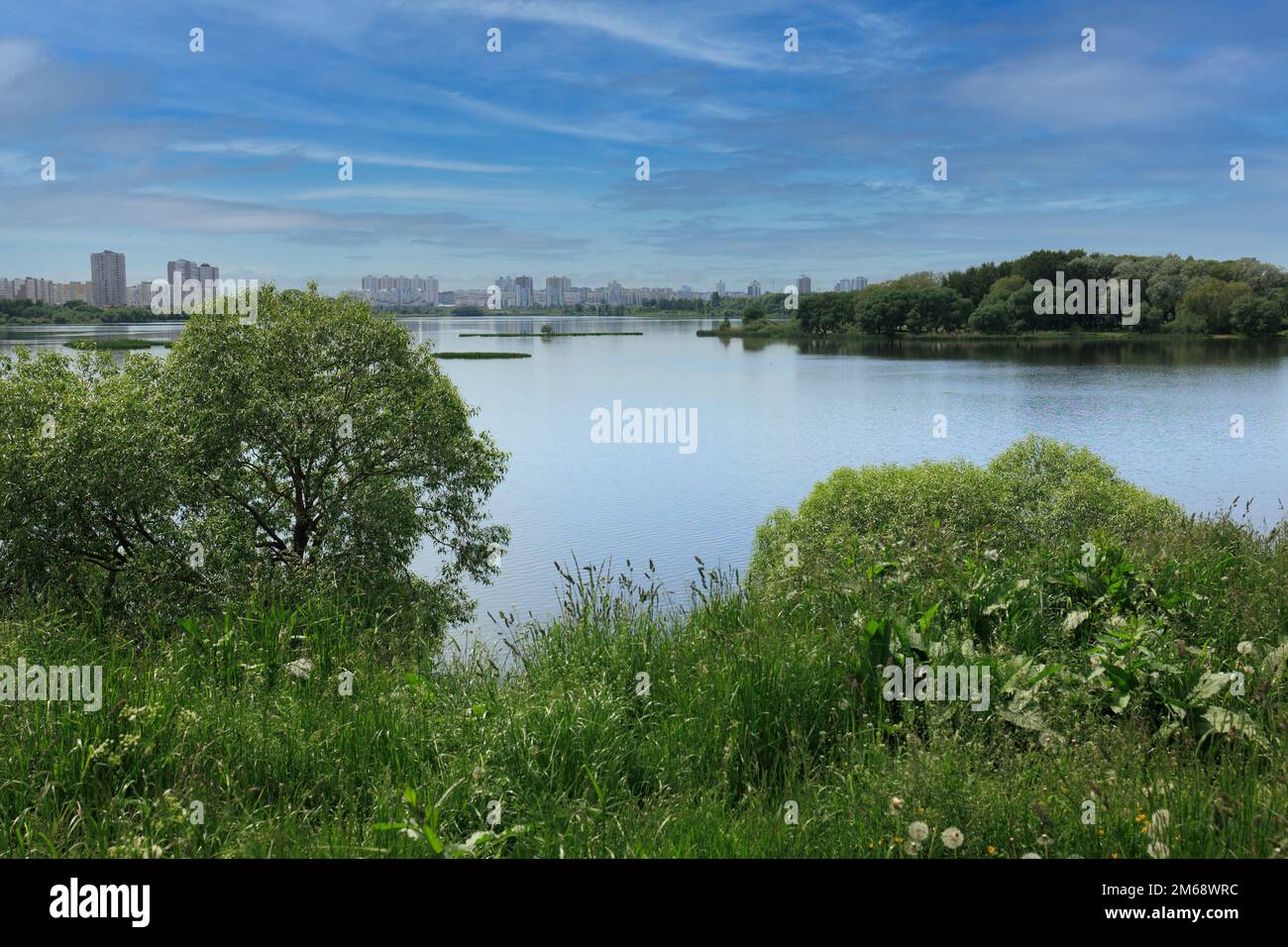 Buildings and houses standing on the shore of a lake, river or sea ...