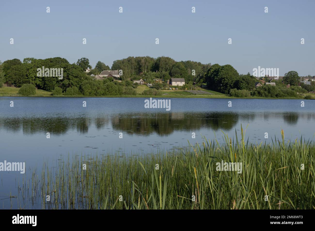 Buildings and houses standing on the shore of a lake, river or sea ...