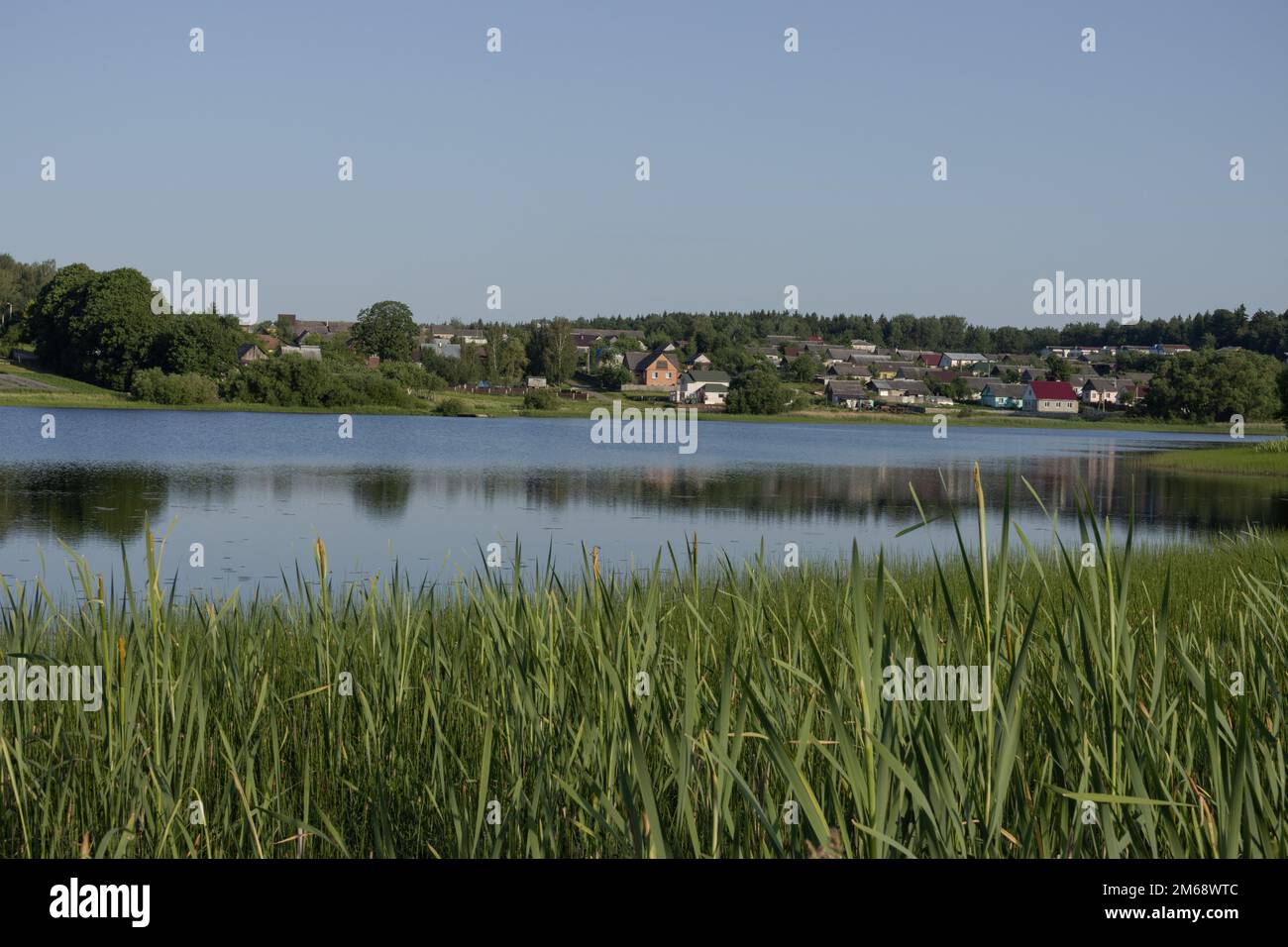 Buildings and houses standing on the shore of a lake, river or sea ...