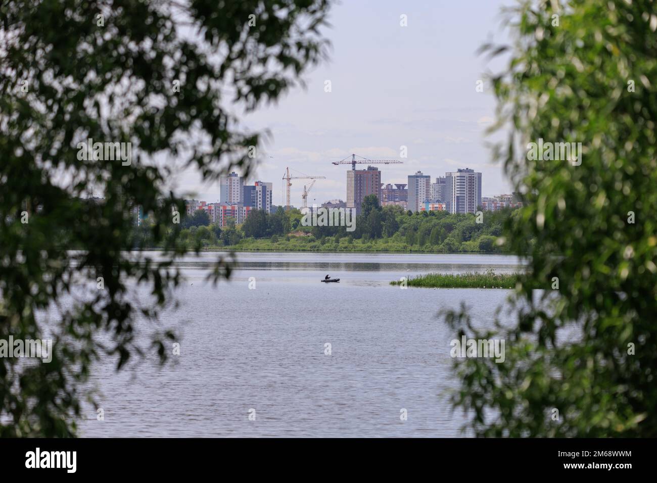 Buildings and houses standing on the shore of a lake, river or sea ...