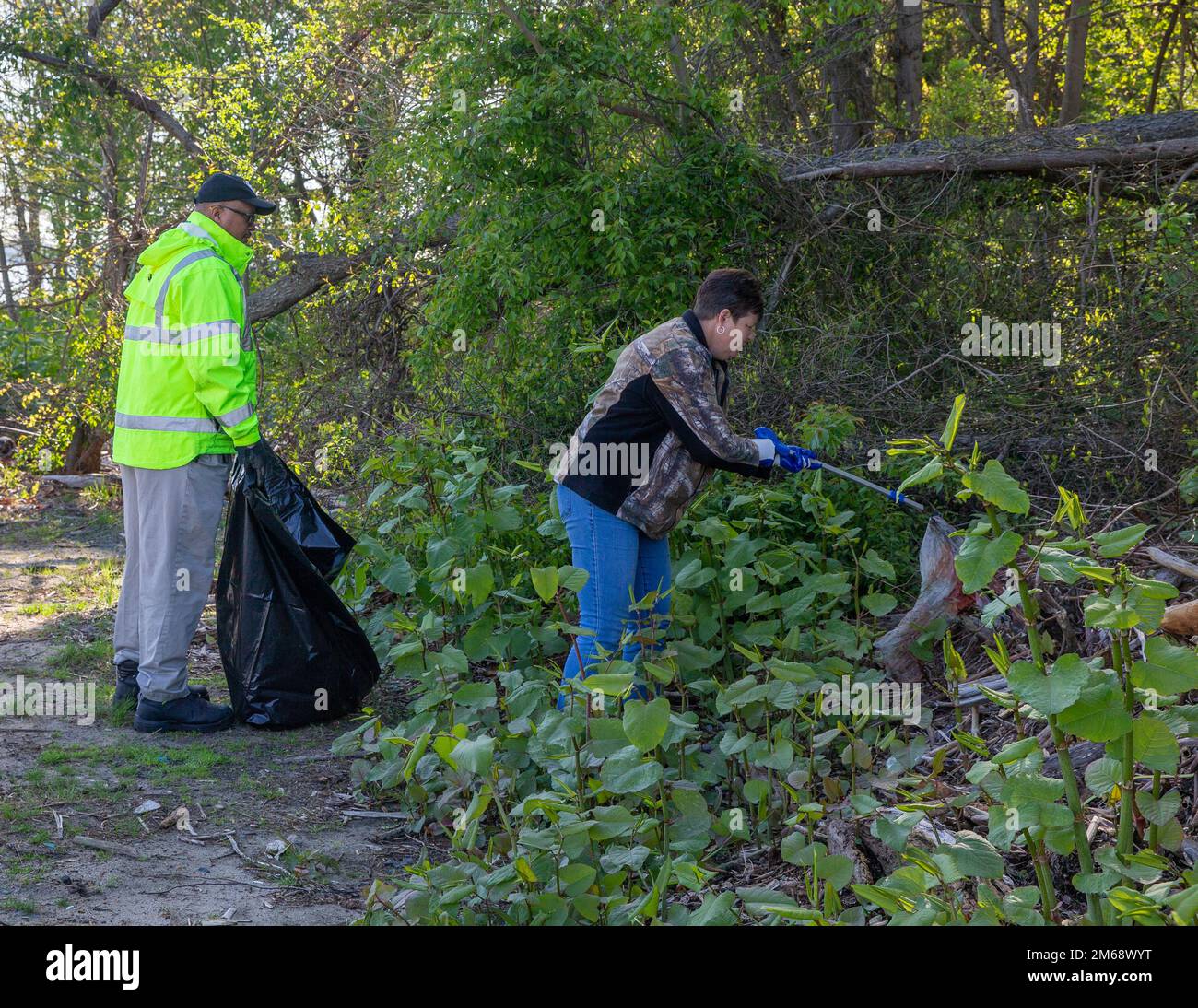 Civilians with Marine Corps Systems Command pick up trash along the ...