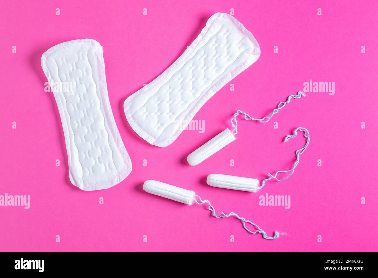 Menstrual tampons and pads on a pink background. Menstruation cycle ...