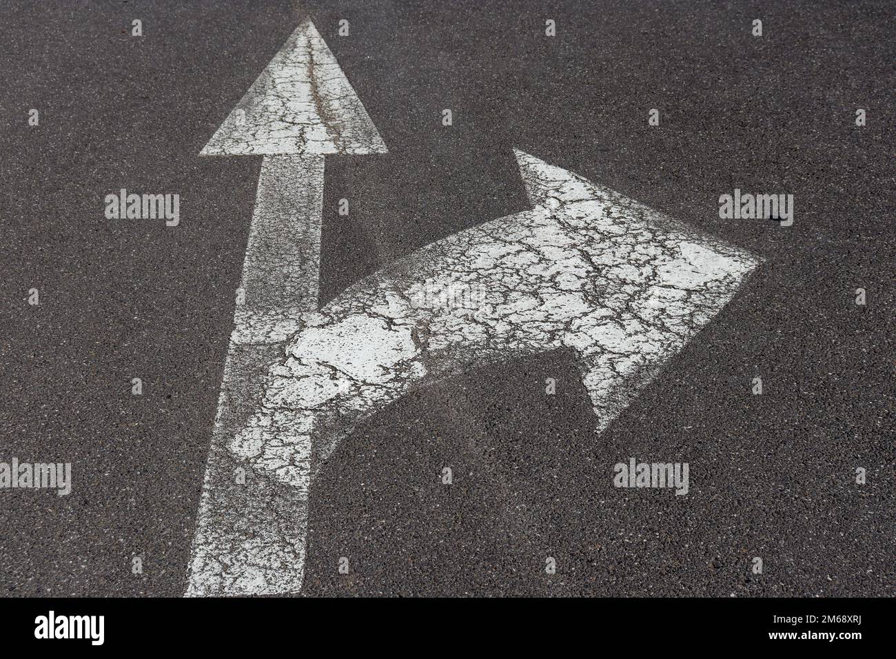 A top view of white arrow print pointing in two different directions on ...