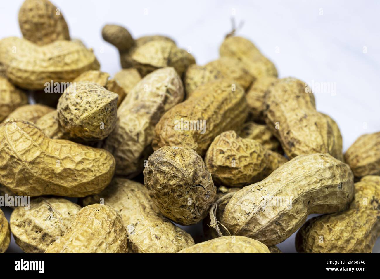 Nuts on a white table Stock Photo - Alamy