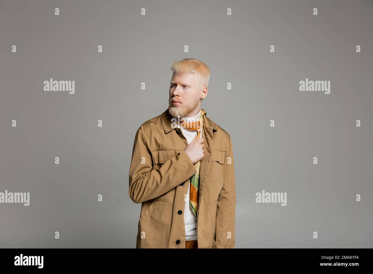 bearded albino man in stylish shirt jacket and silk scarf posing ...