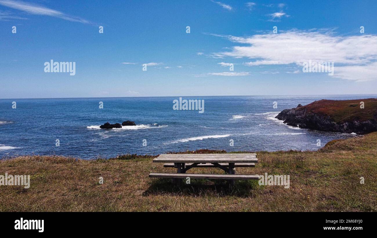 A wooden table with benches on the Goat Rock beach pf Jenner ...