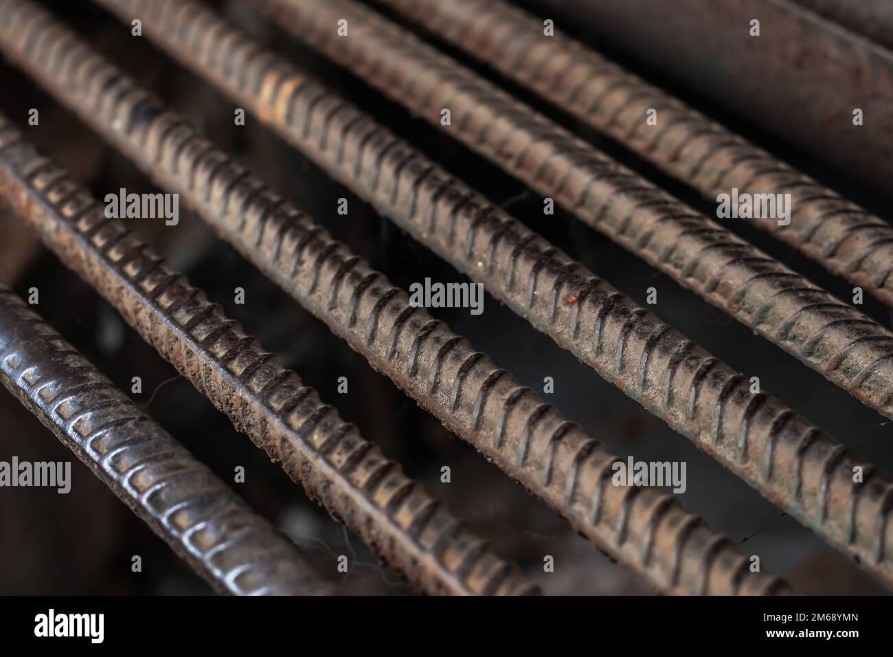 Stack of heavy metal reinforcement bars with periodic profile texture ...